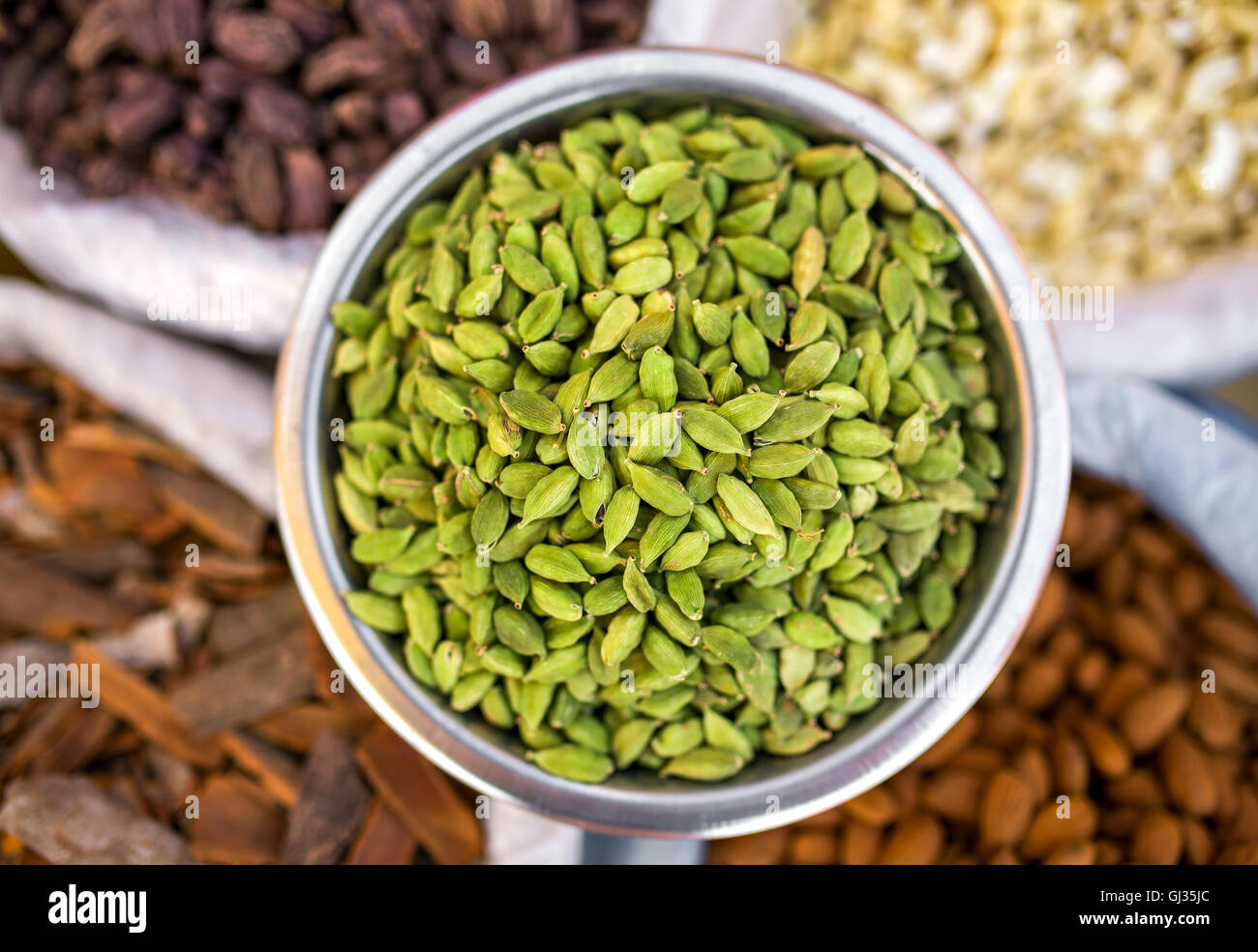Various of Indian spices on the market in India. Cardamon seeds close ...