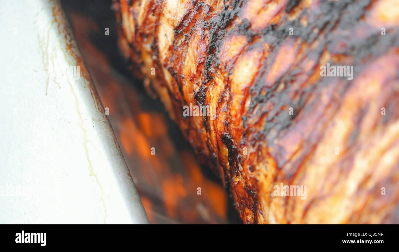 A slightly burned kebab being grilled and rotated on the table Stock ...