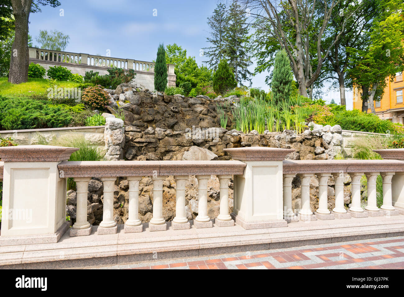 Landscape design with marble fence, many rocks and with background of ...