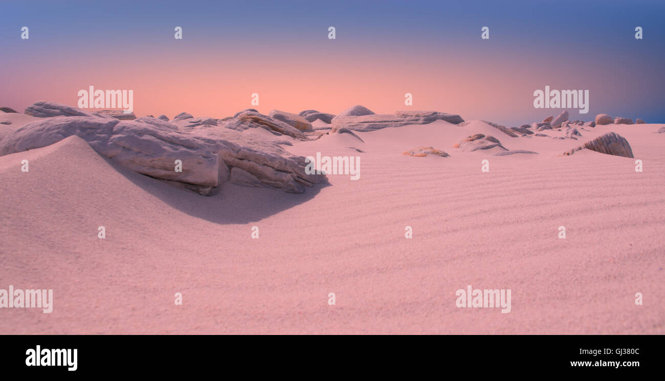 A ground level view of a deserted beach with a pink sunset Stock Photo ...
