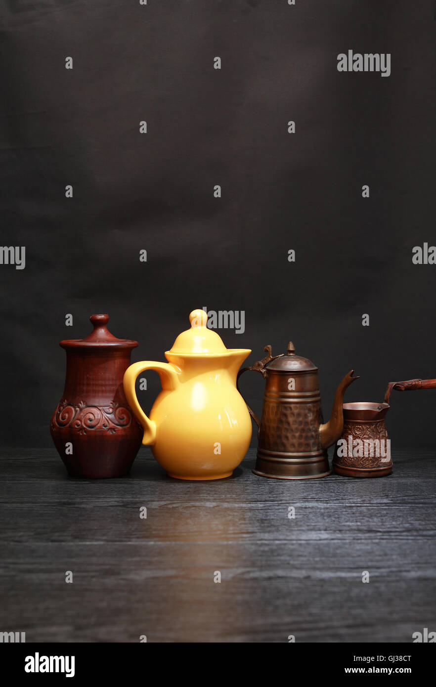 Set of various kitchen dishes on dark background Stock Photo - Alamy