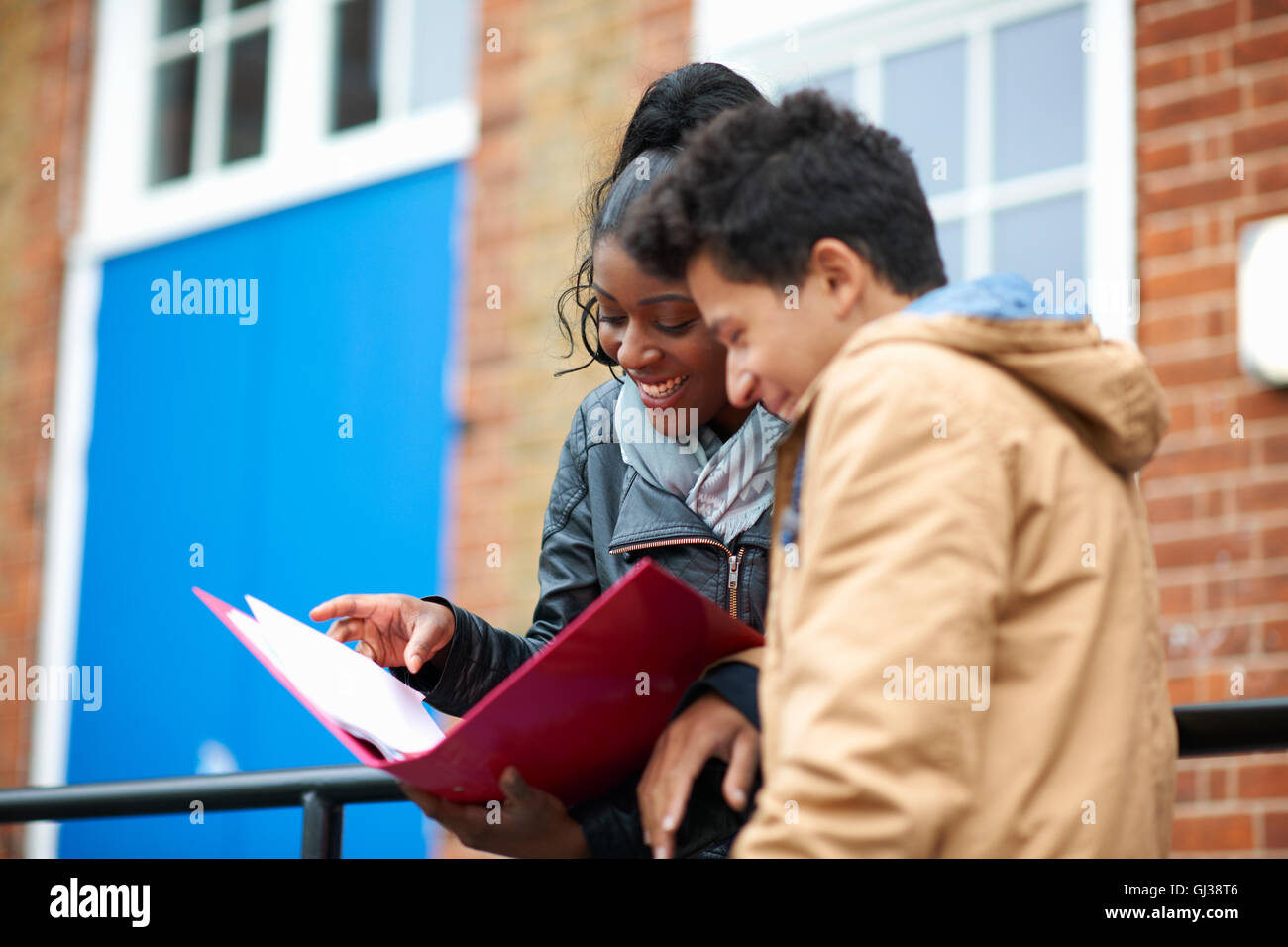 Two young college students revising on campus Stock Photo - Alamy