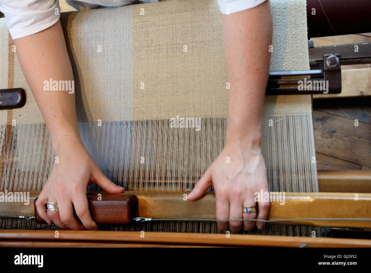 Hands of young woman using loom Stock Photo - Alamy