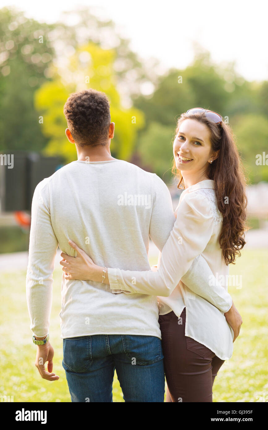 Rear view of couple with arms around each Stock Photo - Alamy