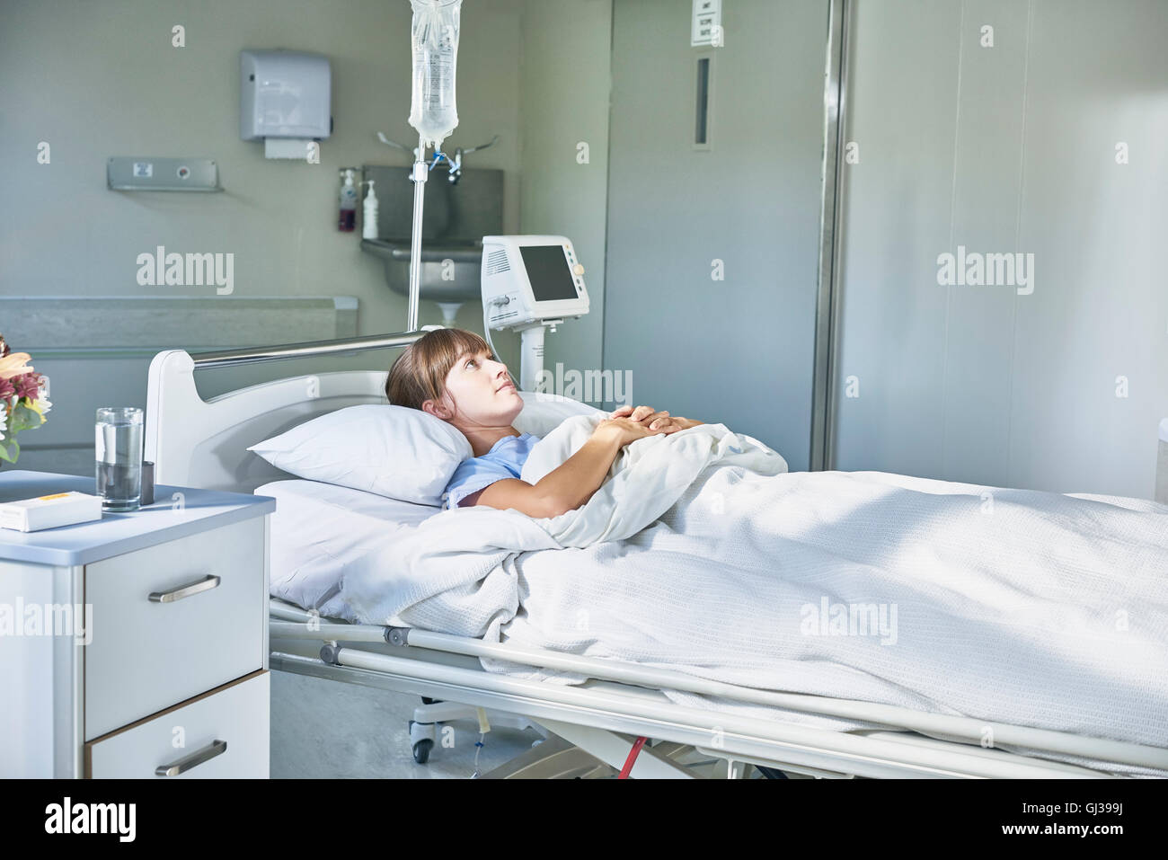 Woman laying down in hospital bed Stock Photo - Alamy