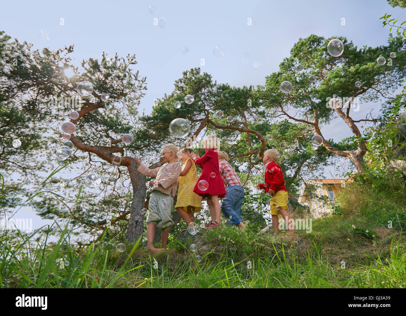 Child watching children playing hi-res stock photography and images - Alamy