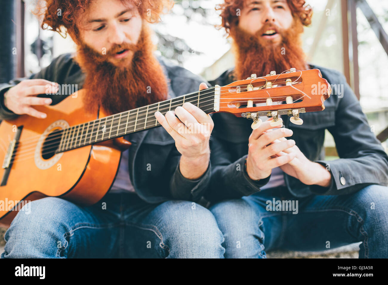 Identical twins playing music hi-res stock photography and images - Alamy