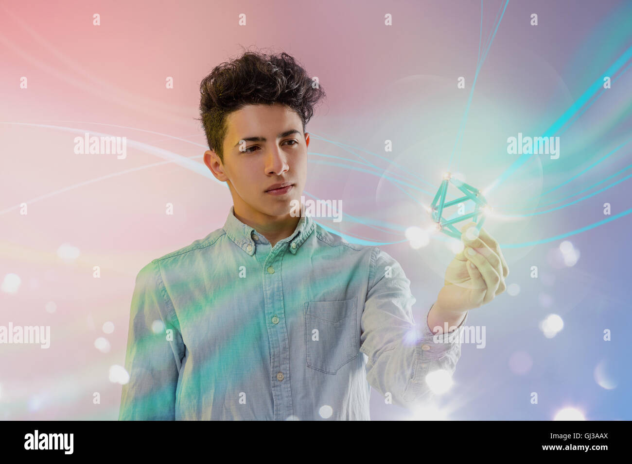 Young man holding 3D shape Stock Photo - Alamy