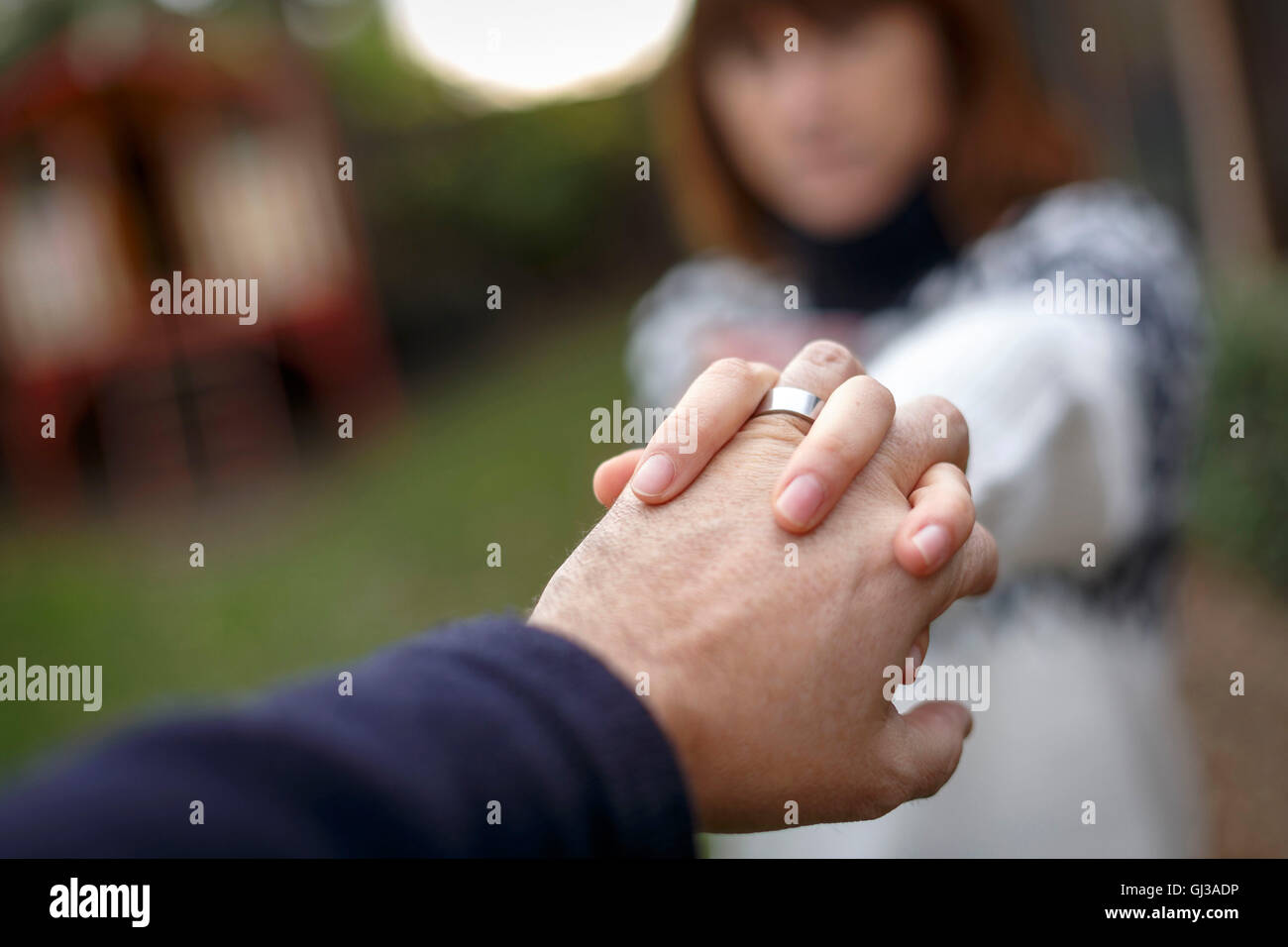 Man and woman holding hands Stock Photo - Alamy