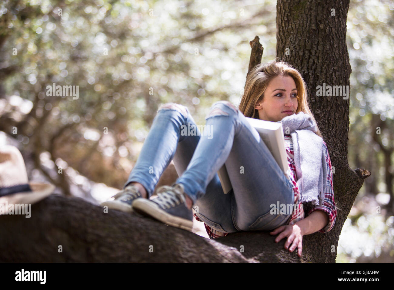 Woman alone sitting tree hi-res stock photography and images - Alamy