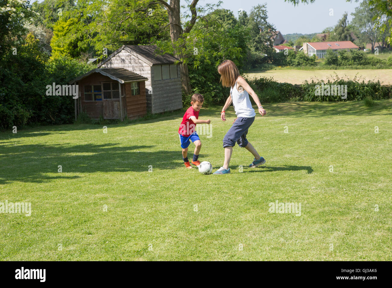Woman playing football on green hi-res stock photography and images - Alamy