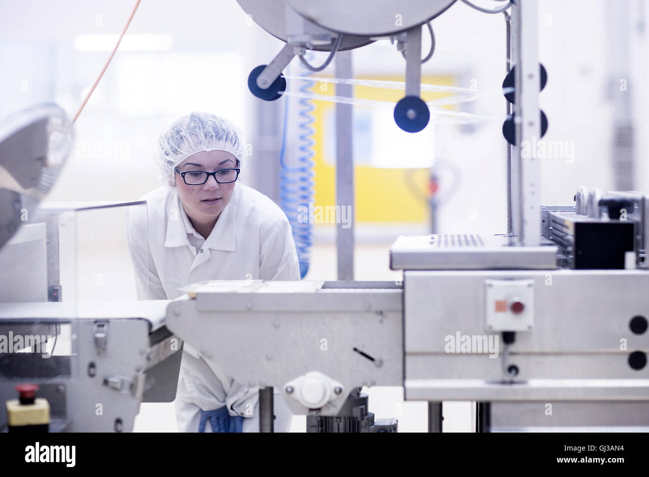 Factory worker operating food production machinery Stock Photo - Alamy