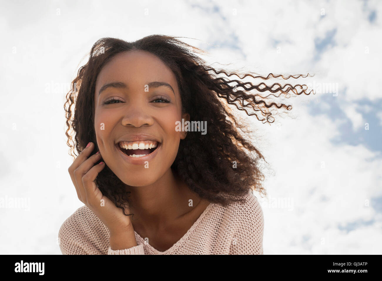 Happy young woman on windy day Stock Photo - Alamy
