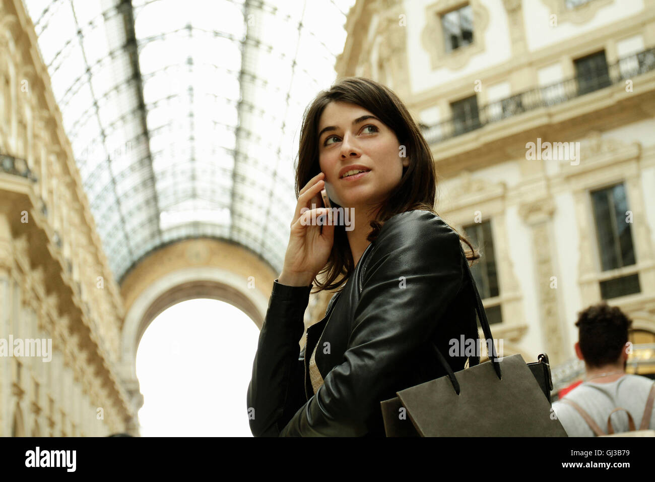 Woman talking on smartphone in Galleria Vittorio Emanuele II, Milan ...