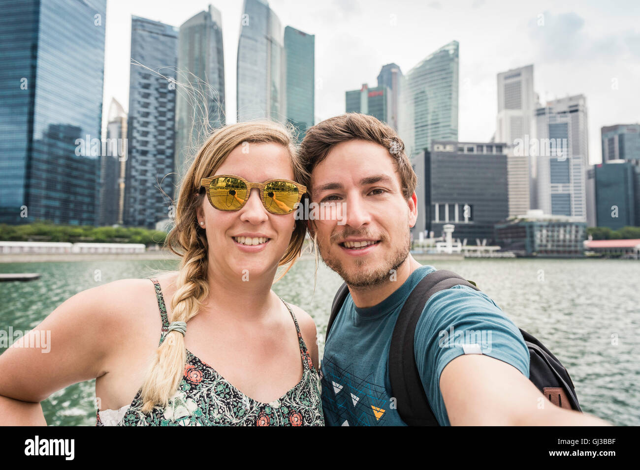 Tourists posing in front of Singapore skyline, Marina Bay Stock Photo ...