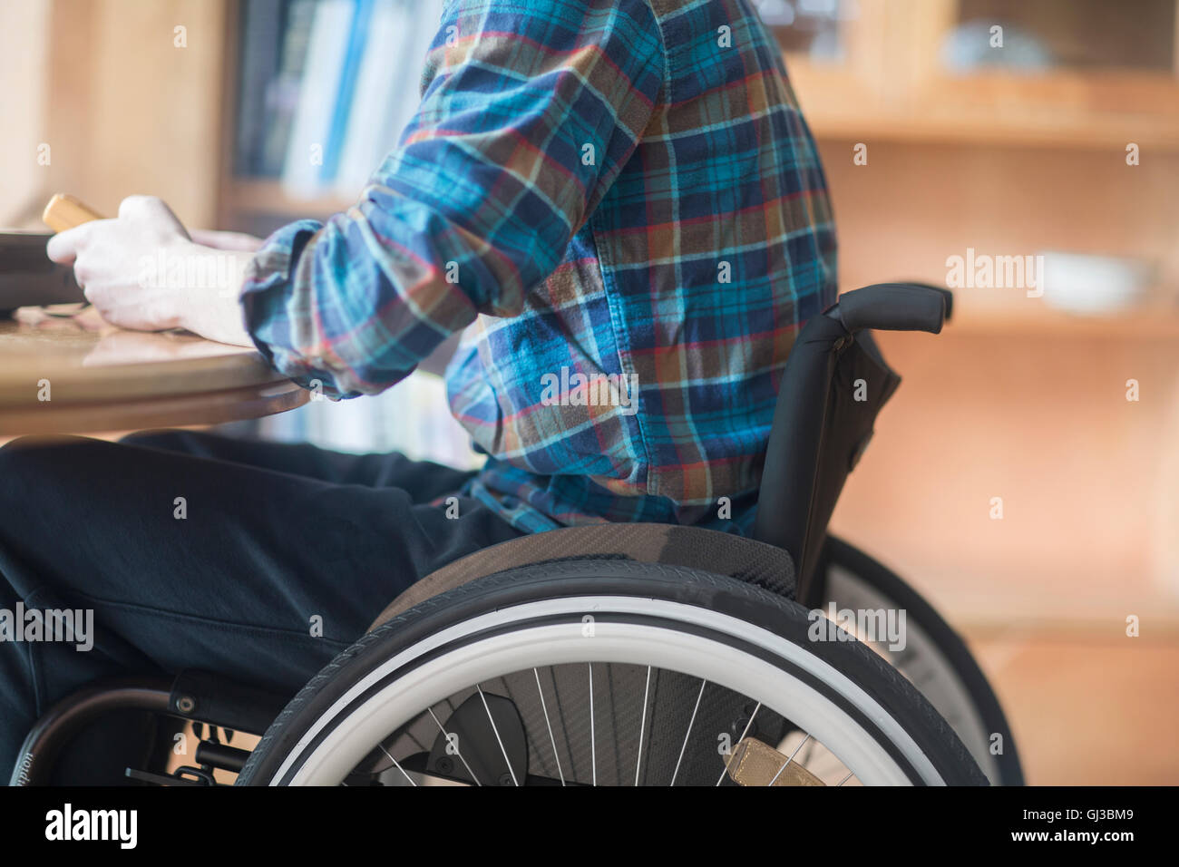 Young man using wheelchair connecting control panel and transformer at ...