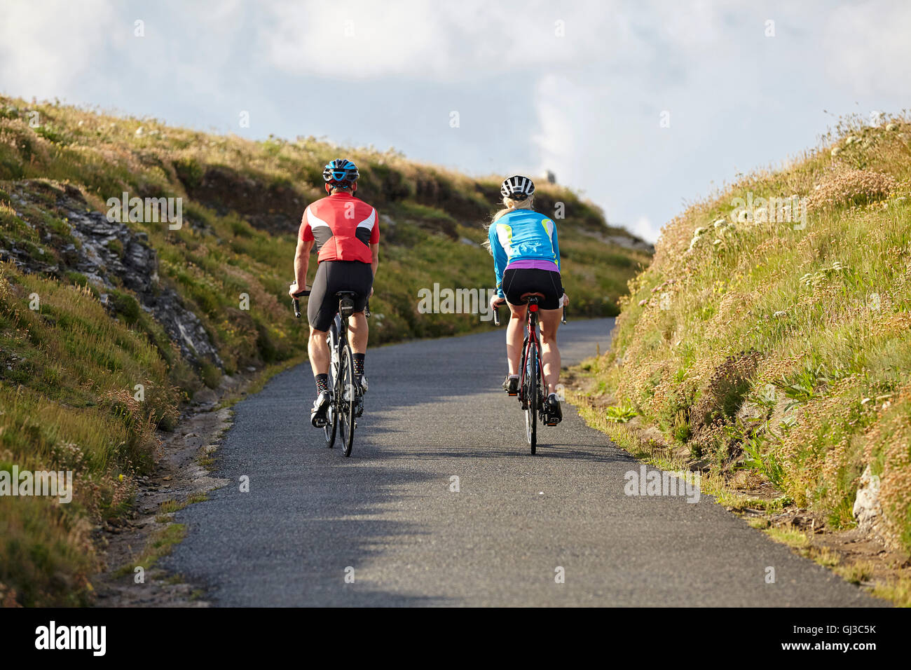 Cyclists riding on country road hi-res stock photography and images - Alamy