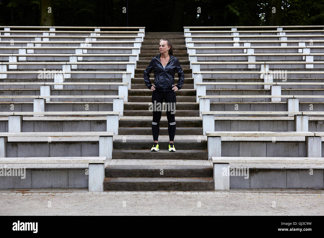 Young woman training, preparing to run on stadium stairway Stock Photo ...