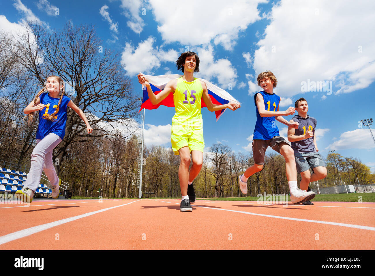 Happy Russian sprinters running on the stadium Stock Photo - Alamy
