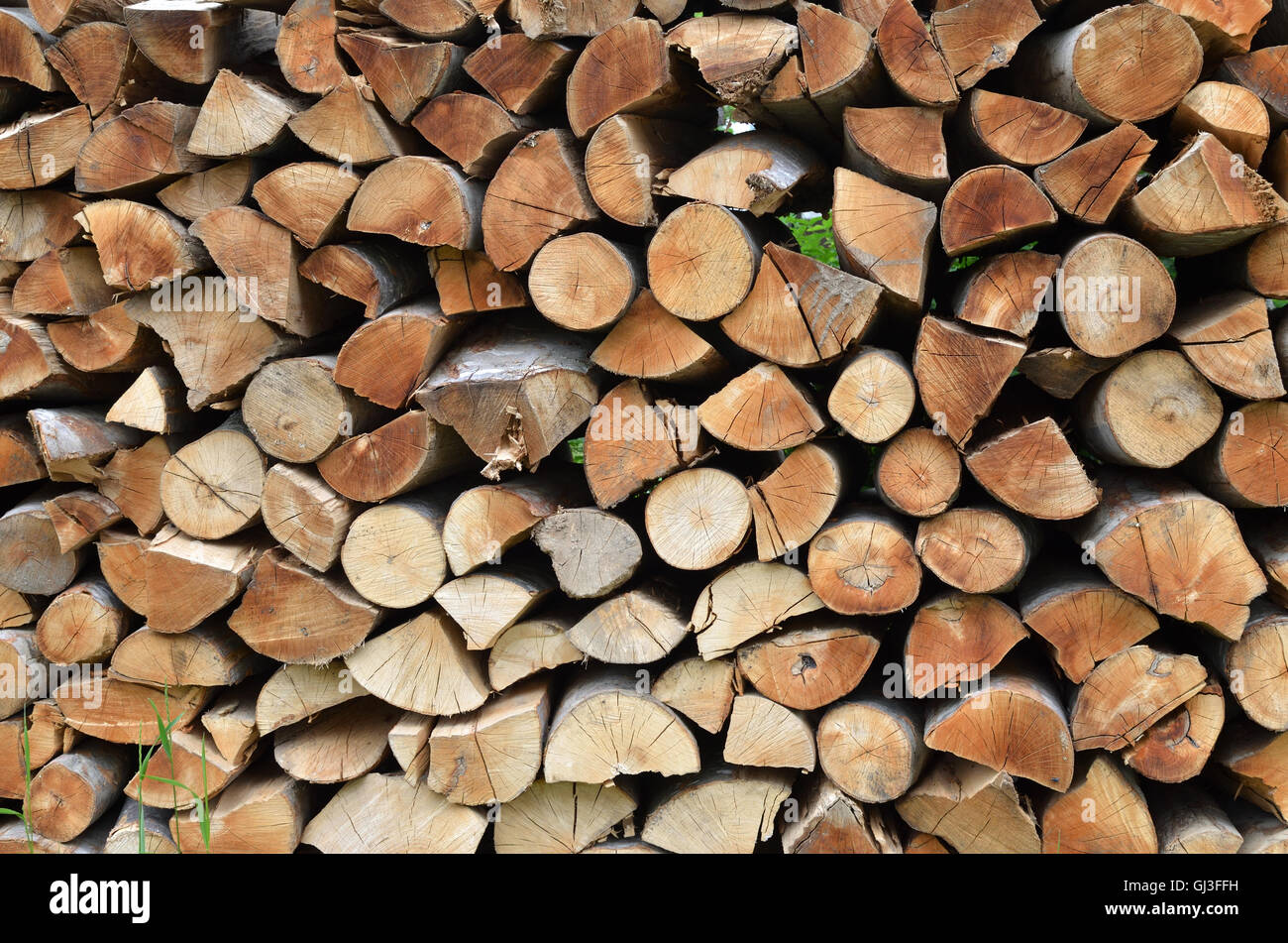 Pile of cut logs as a natural look background Stock Photo - Alamy