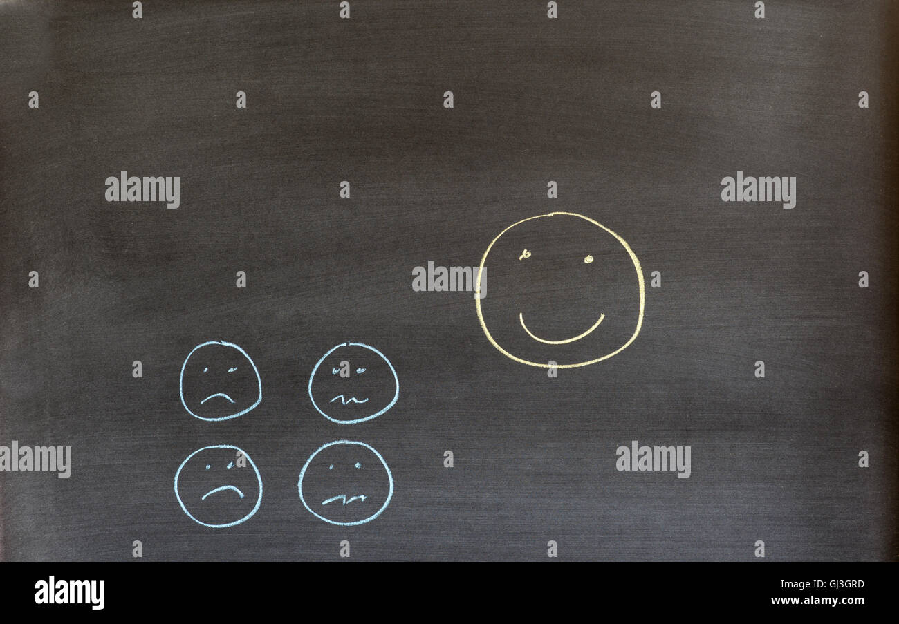 smiley face and faces with frowns drawn on a chalkboard Stock Photo - Alamy