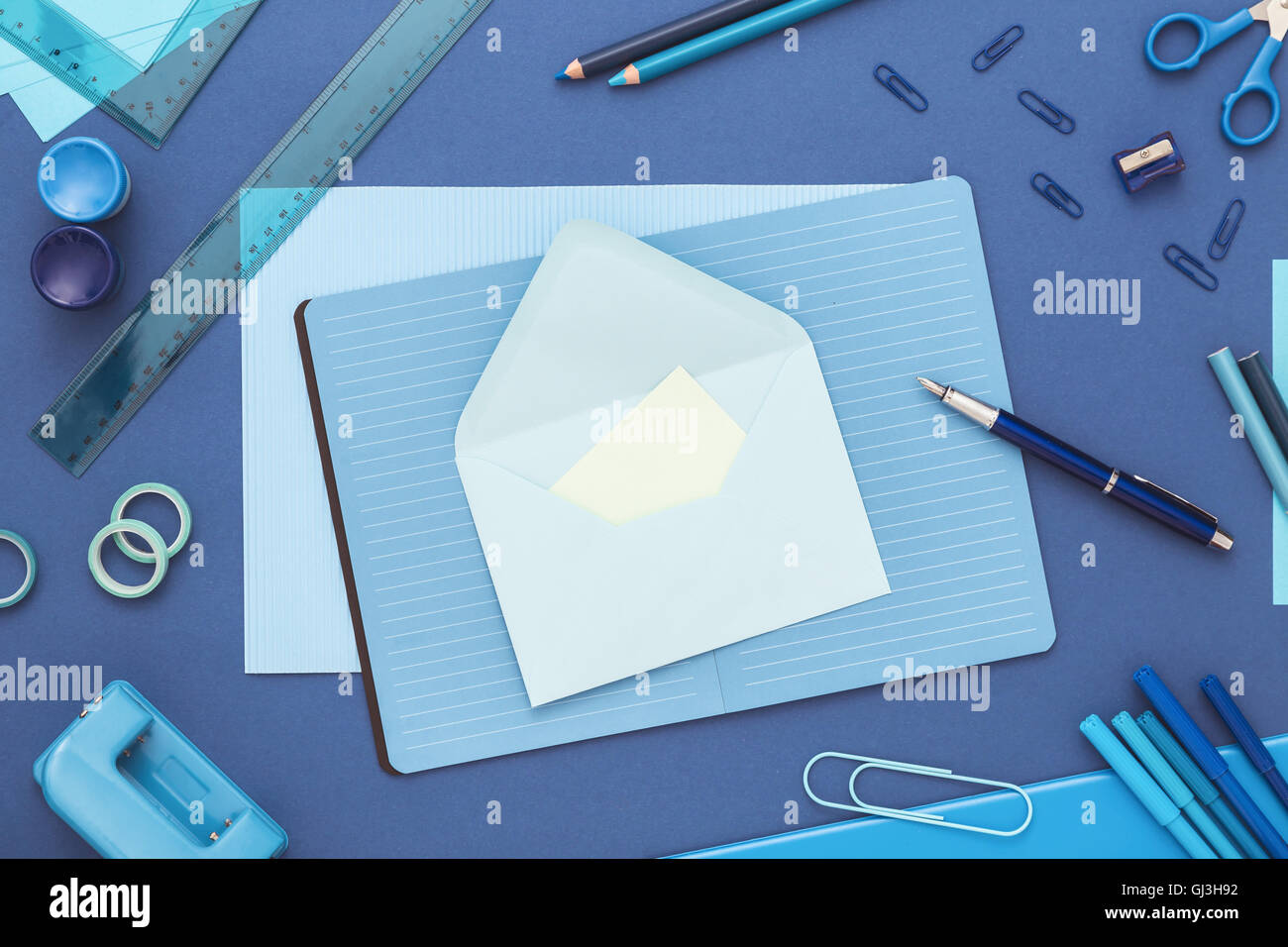 Notebook with envelope opened on the blue background with school ...