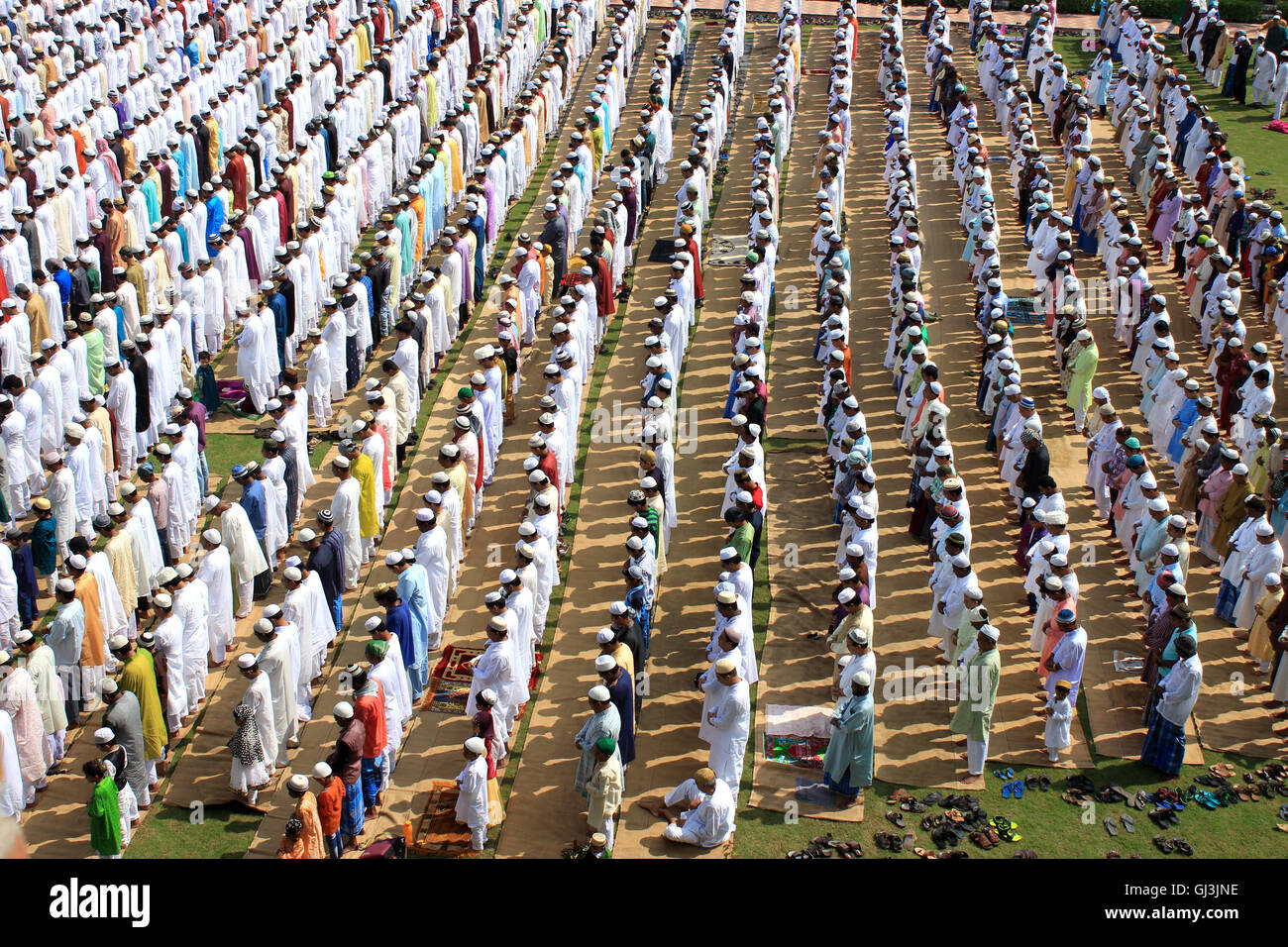 Muslim prayer. A group of Muslim are praying. They wear-ed different ...