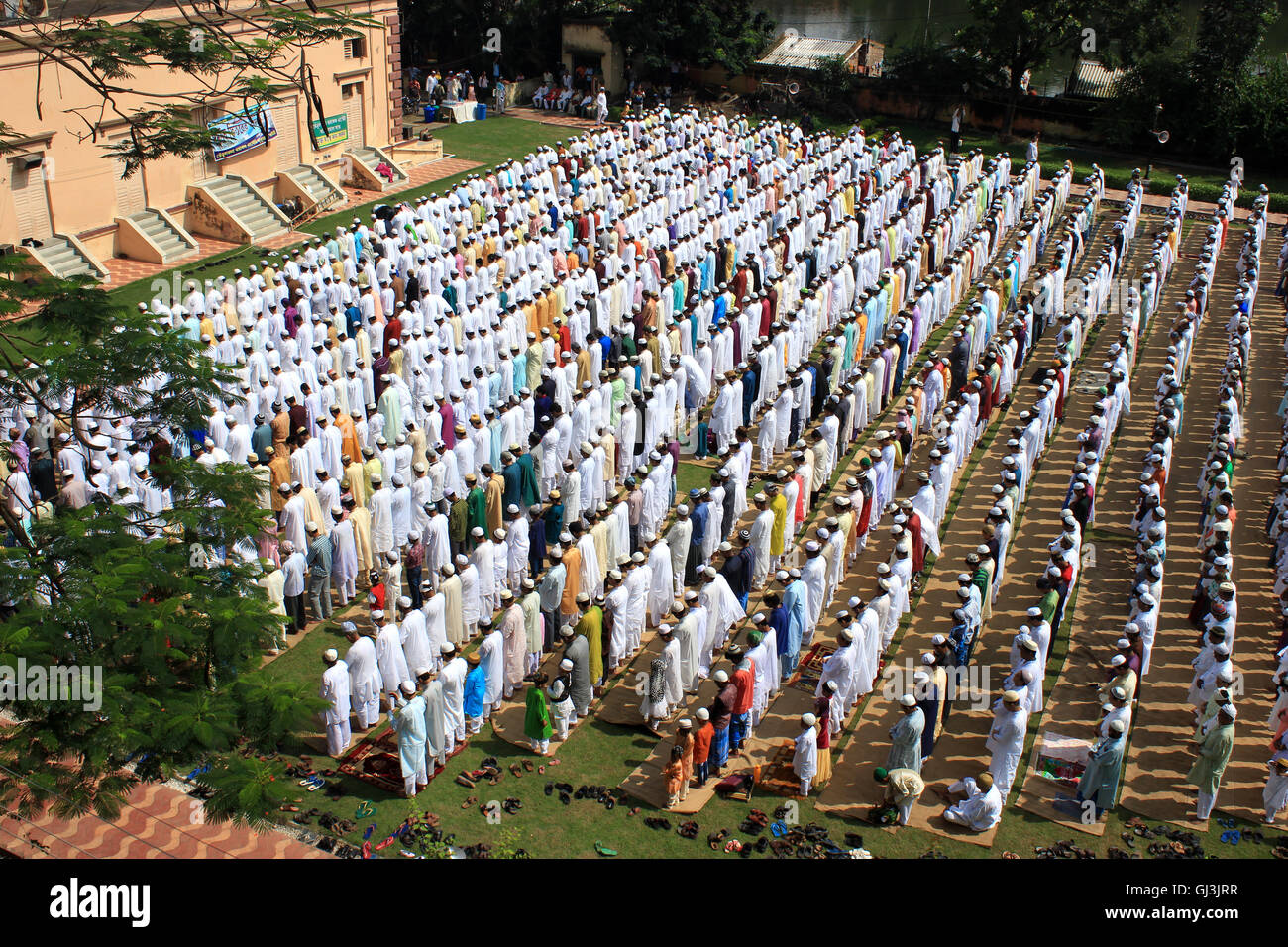 Muslim prayer. A group of Muslim are praying. They wear-ed different ...