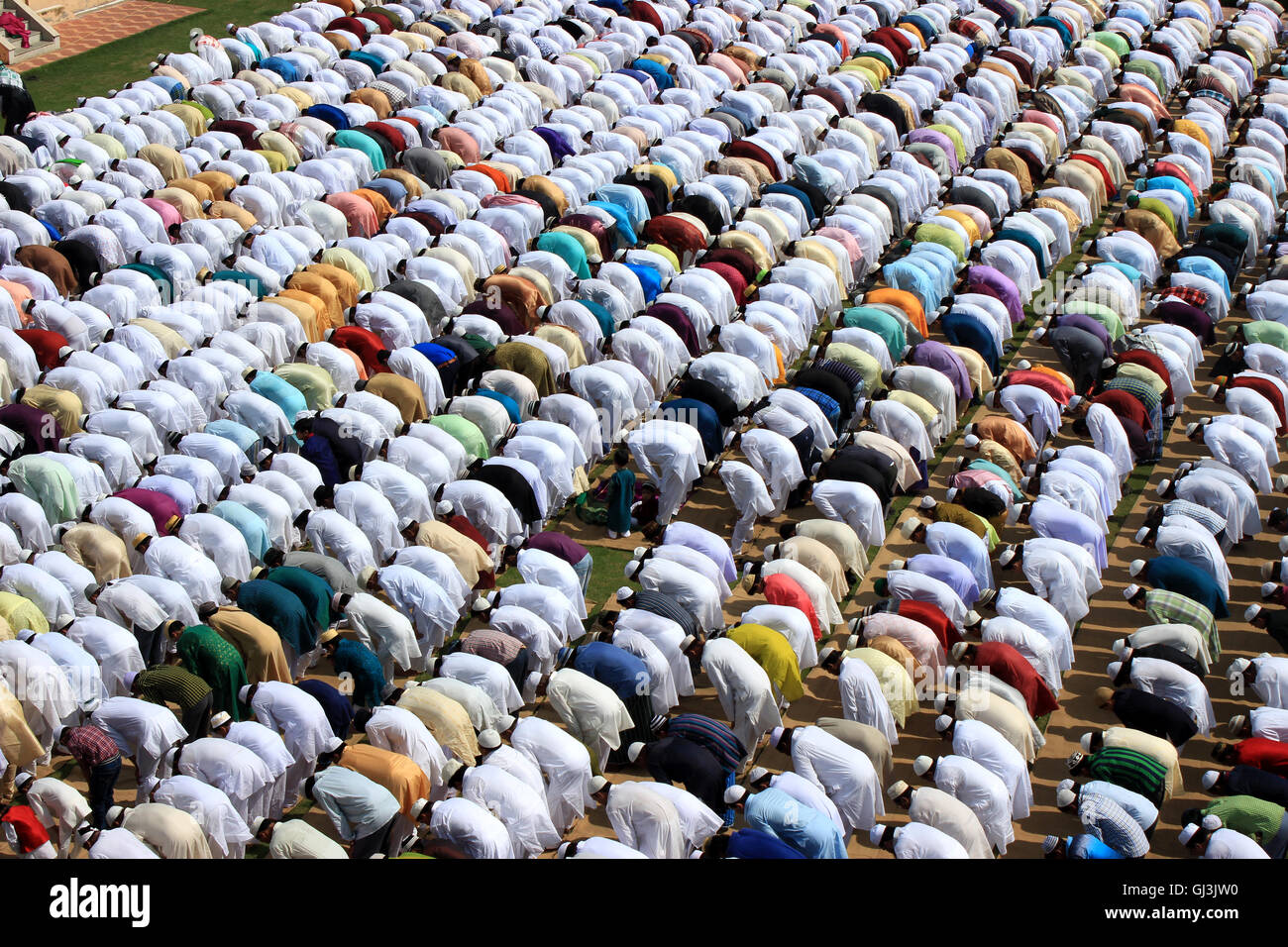 Muslim prayer. A group of Muslim are praying. They wear-ed different ...
