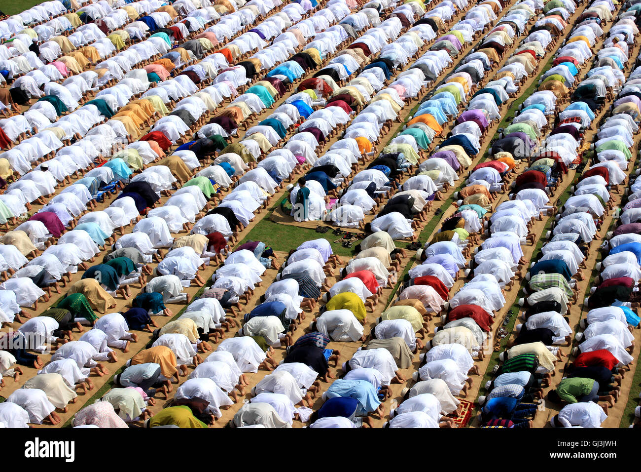 Muslim prayer. A group of Muslim are praying. They wear-ed different ...