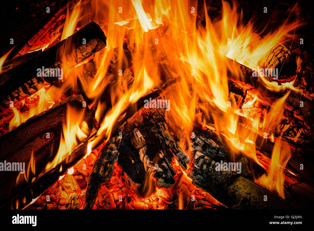 firewood in the bonfire with fire and sparks Stock Photo - Alamy
