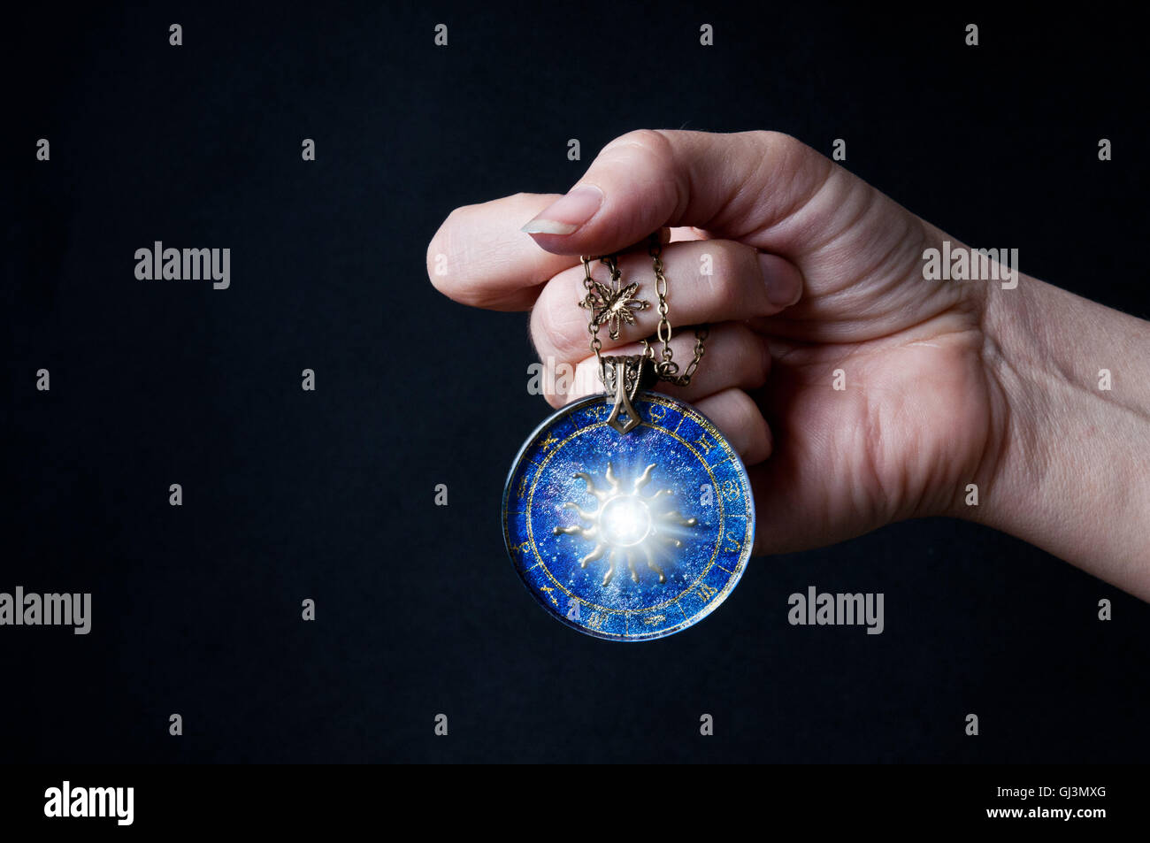 hand holding an astrological amulet Stock Photo - Alamy