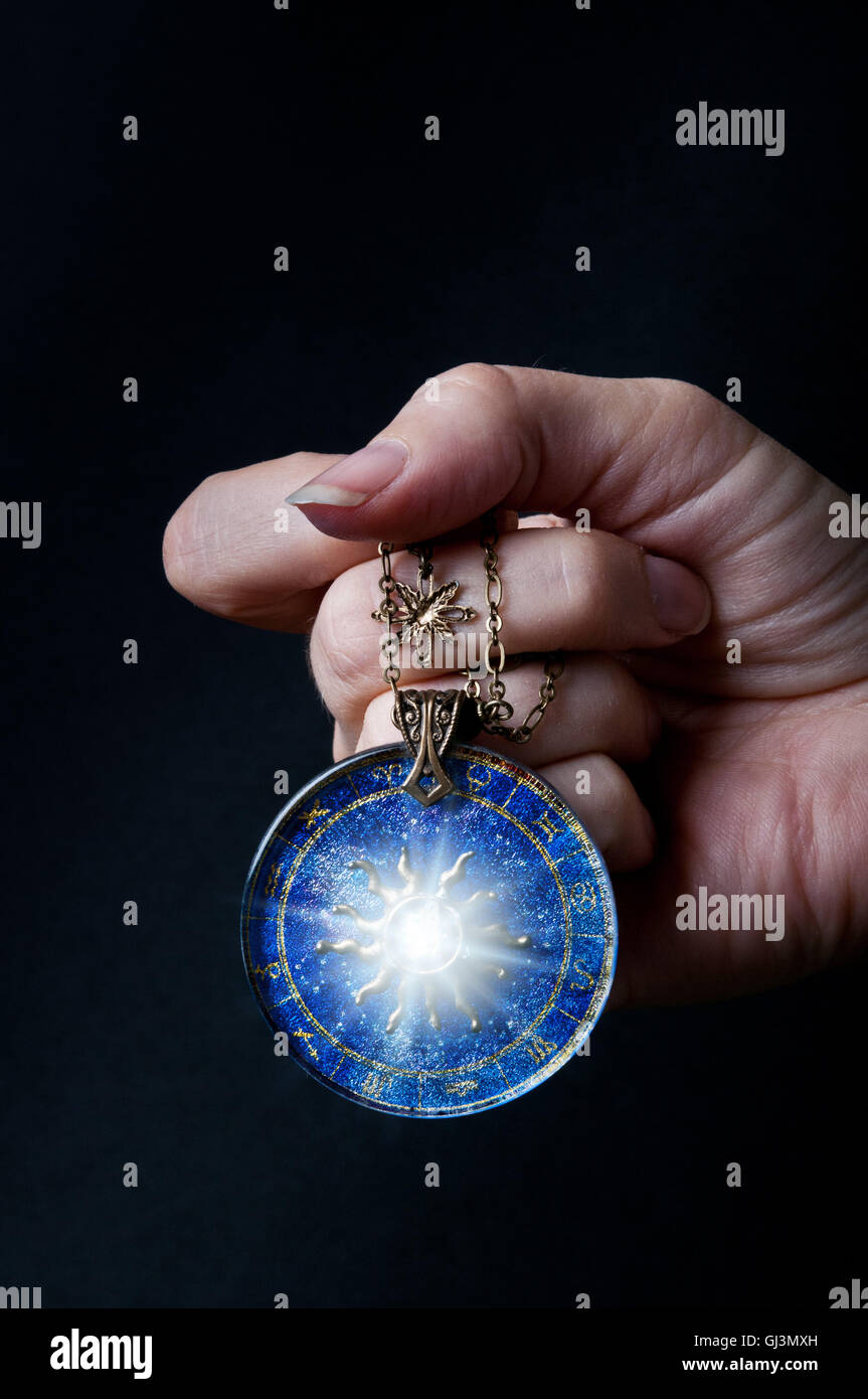 Hand holding astrological amulet hi-res stock photography and images ...
