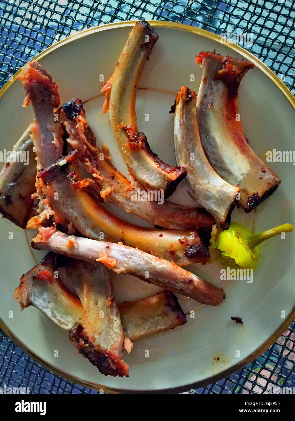 Plate of eaten pork ribs, Flat Lay Stock Photo - Alamy