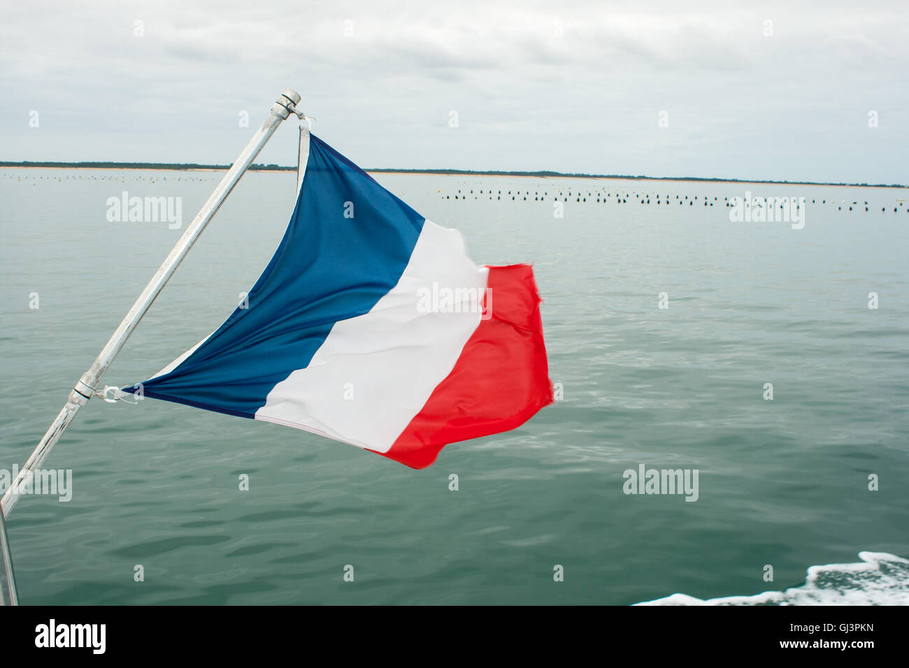 The French flag waves on a boat Stock Photo - Alamy