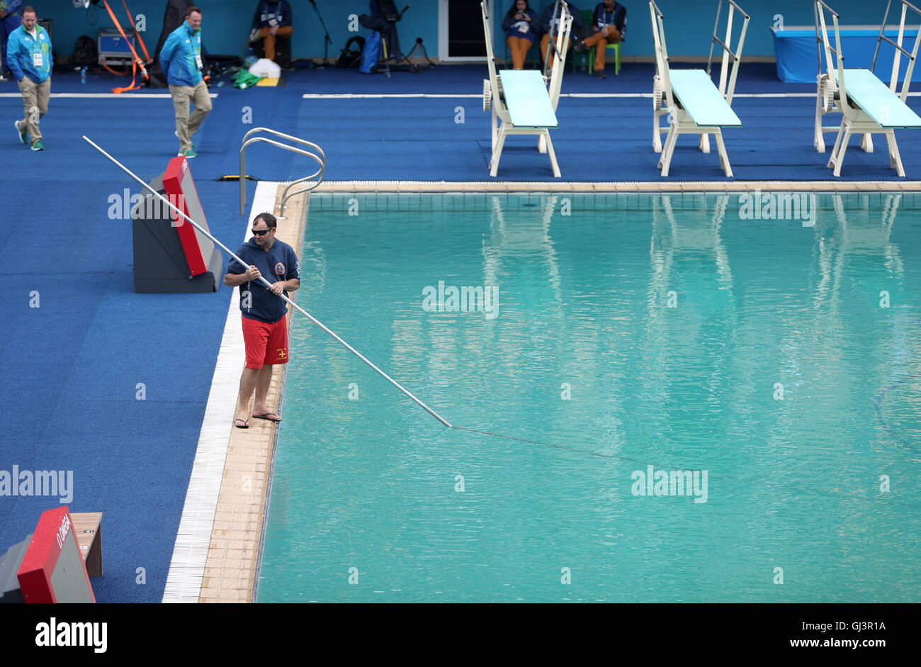 Pool staff clean the diving pool at the Maria Lenk Aquatics Centre on ...