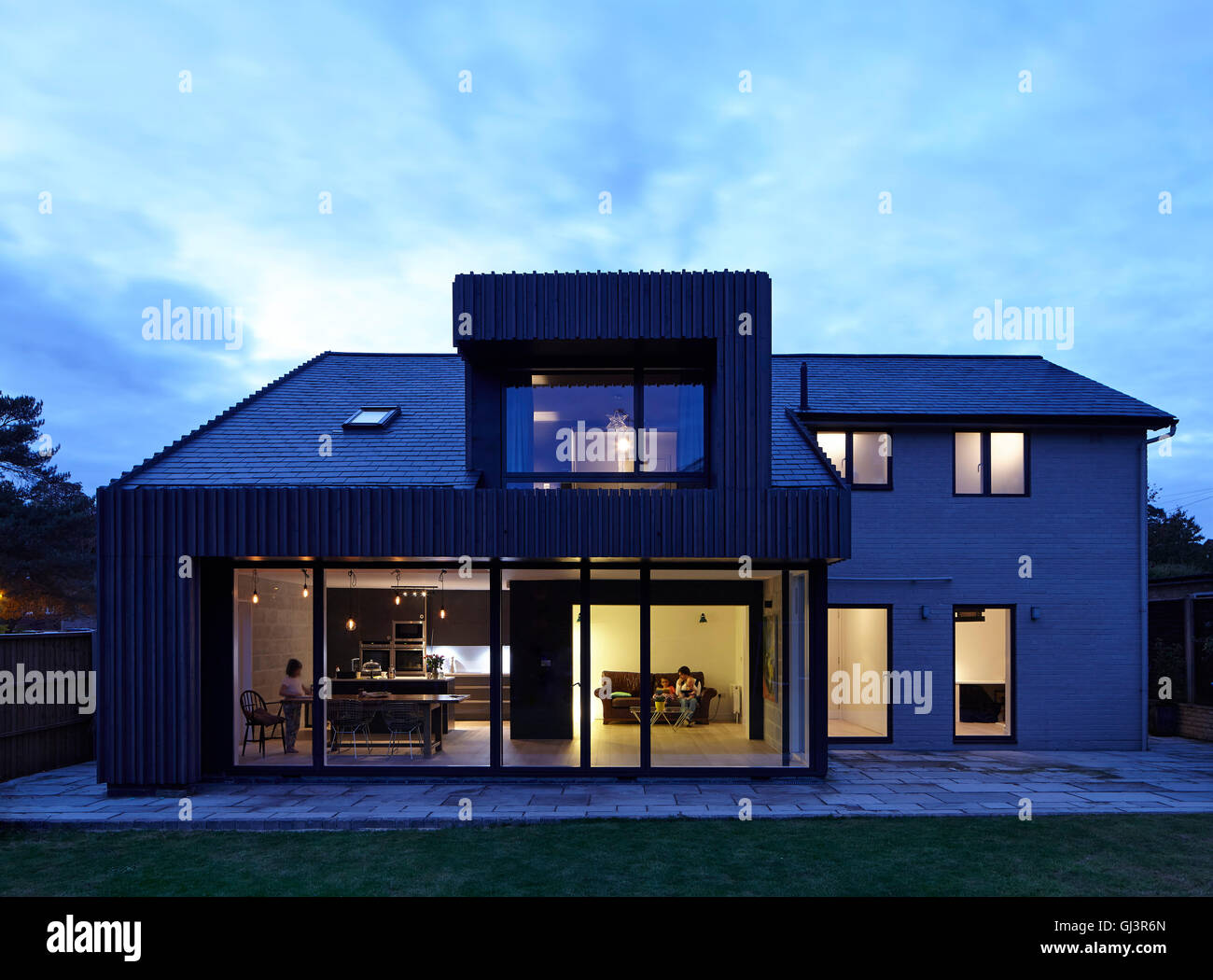 Rear elevation at dusk showing extension and original house. Paired ...