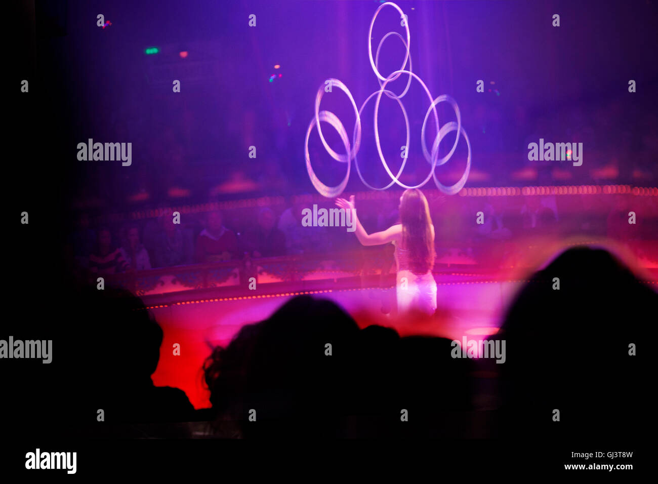 Artiste (female) with hoops in circus ring with audience Stock Photo ...