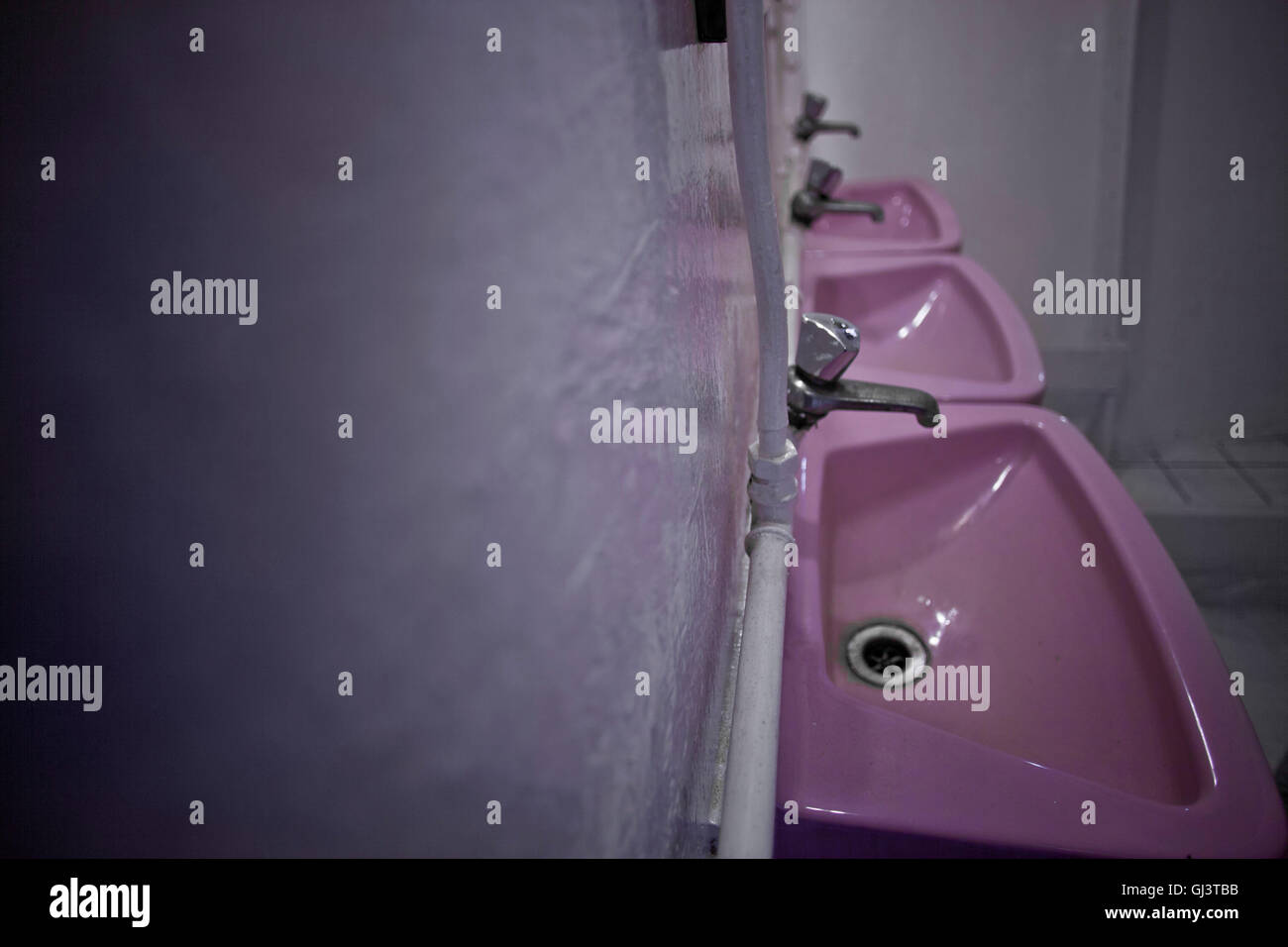 three rose Coloured sinks Stock Photo - Alamy
