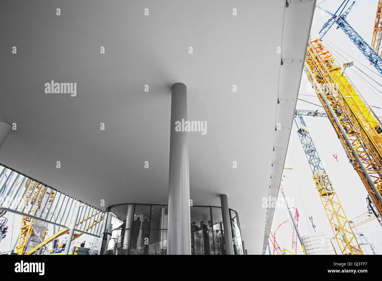 Modern architecture between construction cranes Stock Photo - Alamy