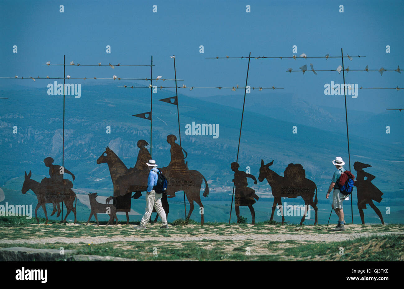 Pilgrims next to statue of medieval pilgrims on the summit of Sierra ...