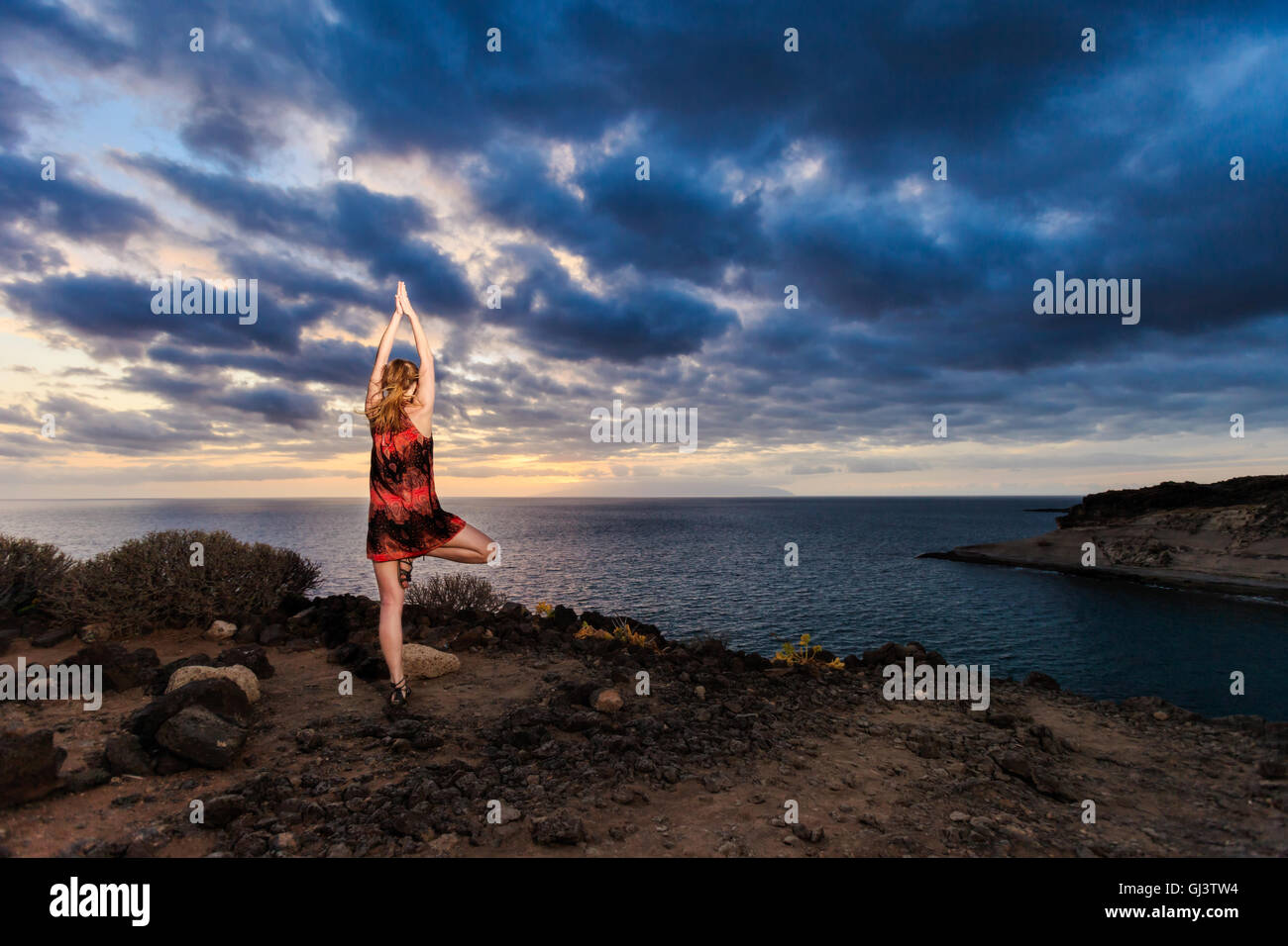 Summer sunset yoga session on beautiful Playa Fanabe beach - tropical ...