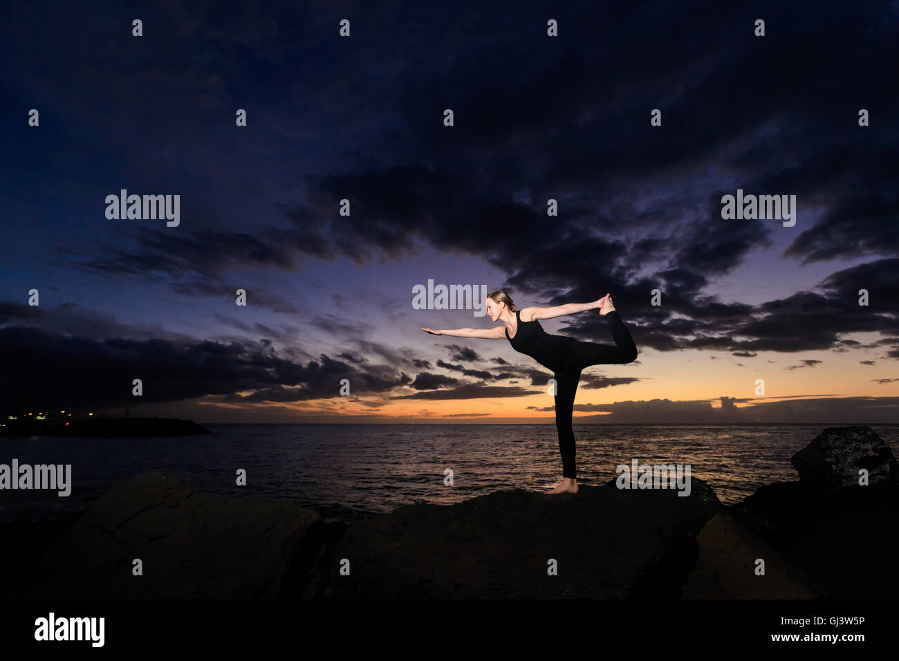Summer sunset yoga session on beautiful Playa Fanabe beach - tropical ...
