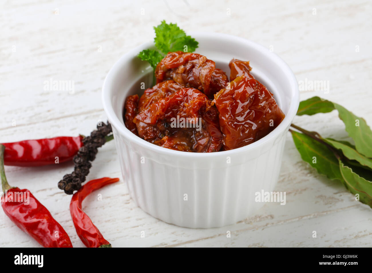 Dry tomato in olive oil with pepper Stock Photo - Alamy