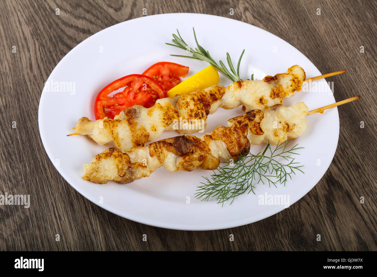 Fish skewer with dill, tomato and lemon Stock Photo - Alamy