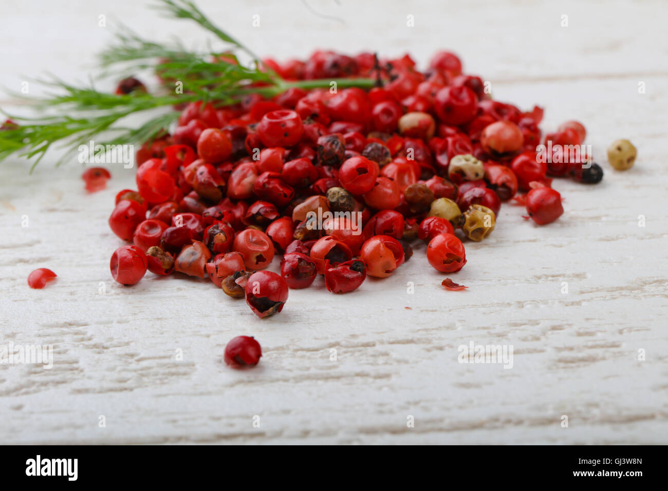 Red pepper corn on the wood background Stock Photo - Alamy