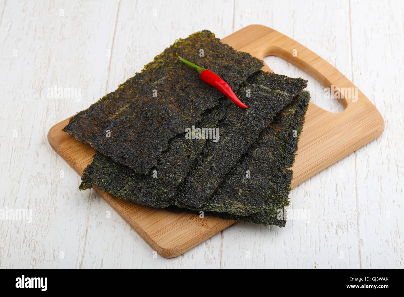 Spicy Nori seaweed sheets with pepper on wood Stock Photo - Alamy