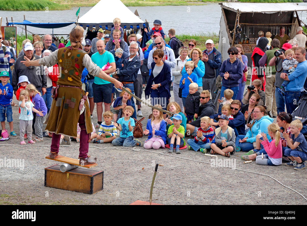 A juggler entertains audience while performing outdoors Stock Photo - Alamy