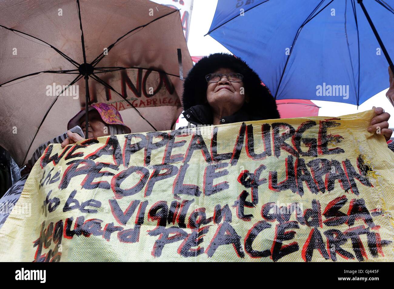 Pasay City, Philippines. 12th Aug, 2016. Activists hold placards during ...