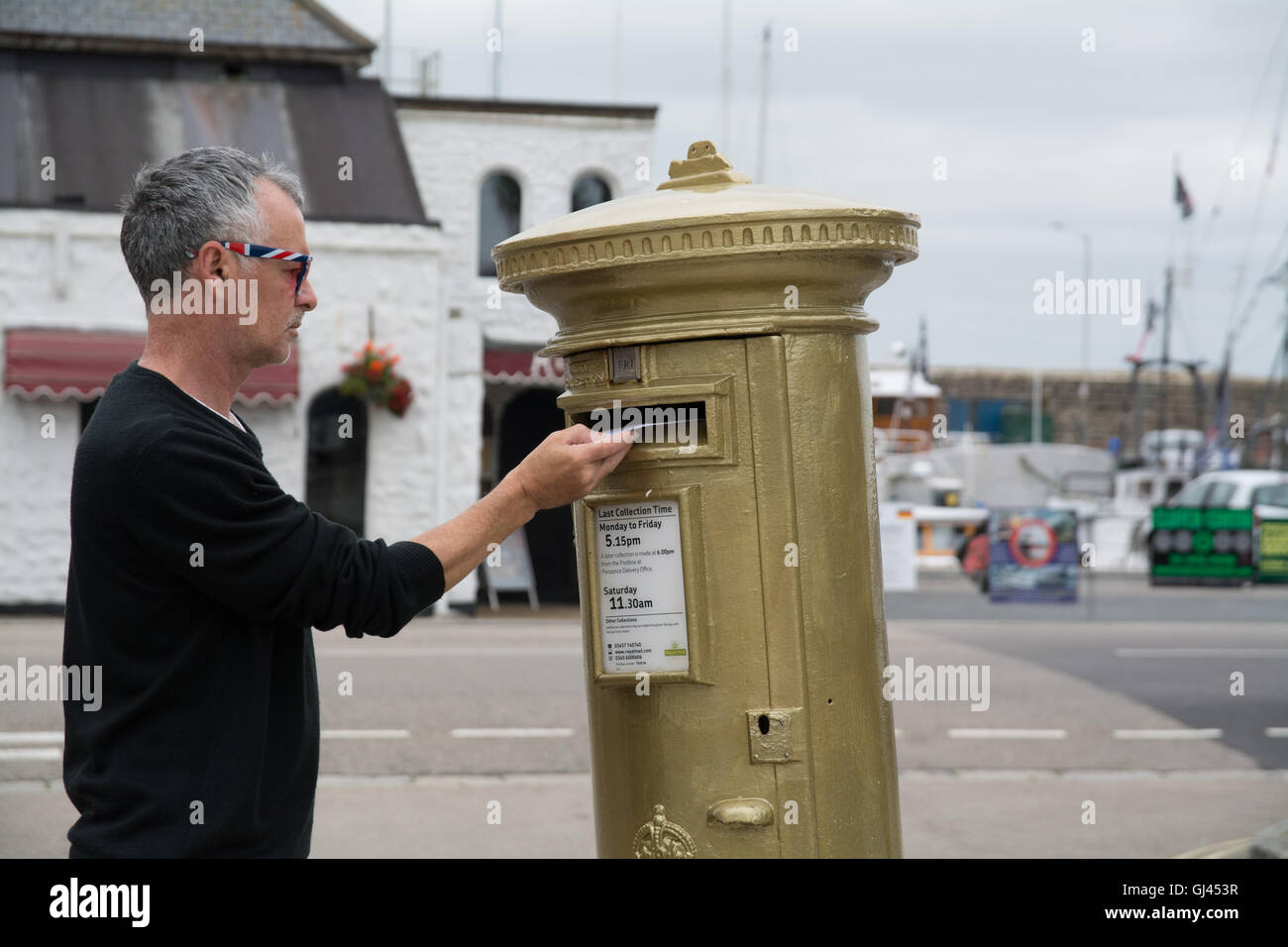Penzance, Cornwall, UK. 12th August 2016. The golden postbox in ...